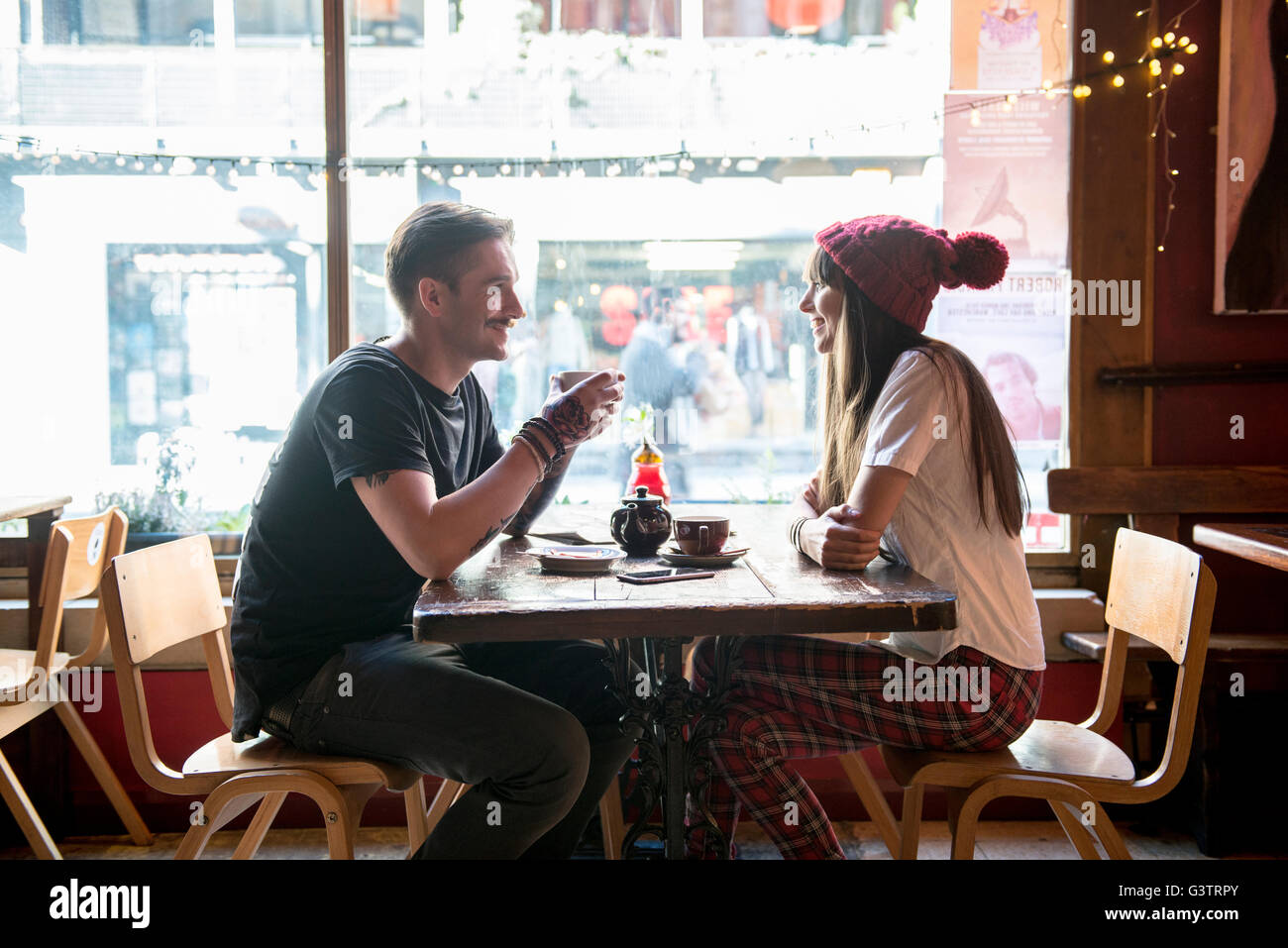 A young couple enjoying being with each other in a coffee shop in ...