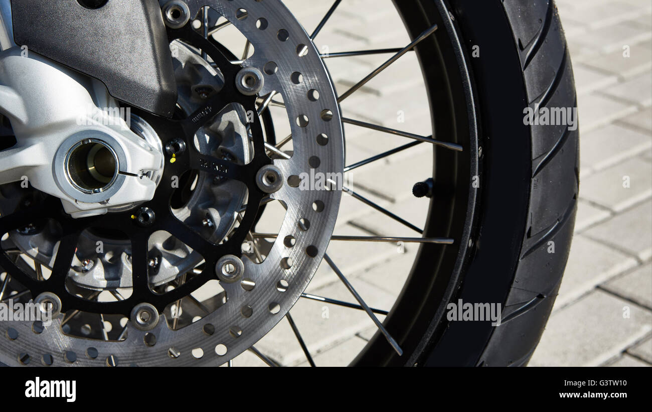 The Front motorcycle disk breaks and tire in close up Stock Photo - Alamy