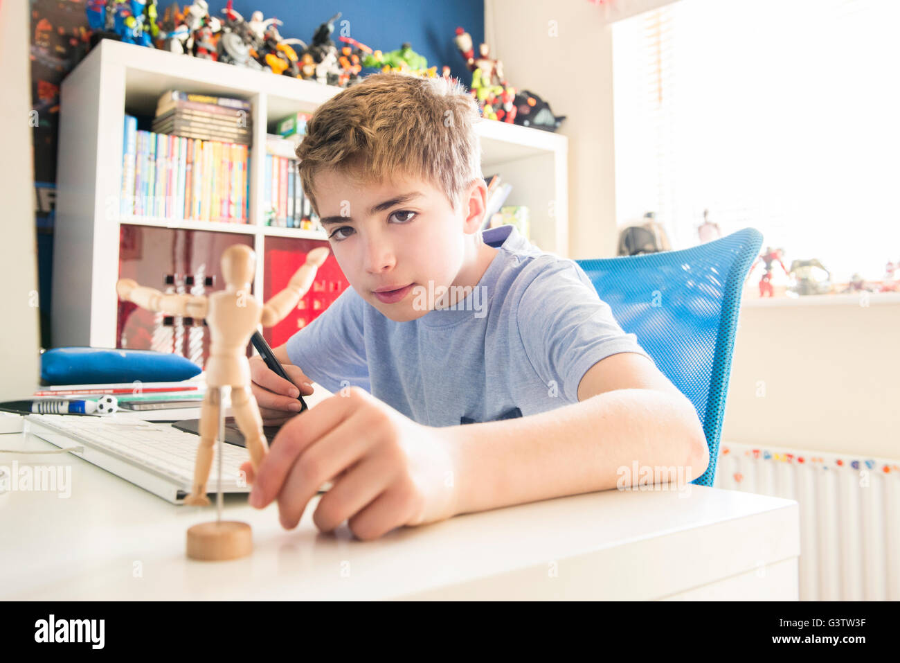 Boy sitting desk in bedroom hi-res stock photography and images - Alamy