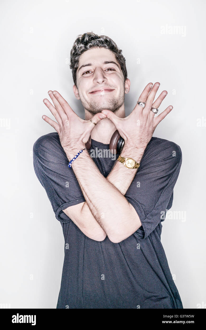 A young man posing in a studio making hand gestures Stock Photo - Alamy
