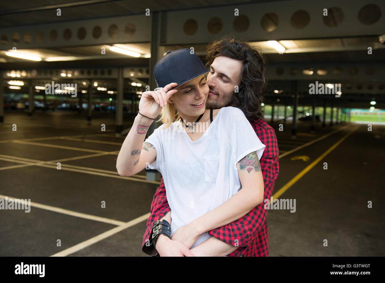 A cool young couple cuddling Stock Photo - Alamy