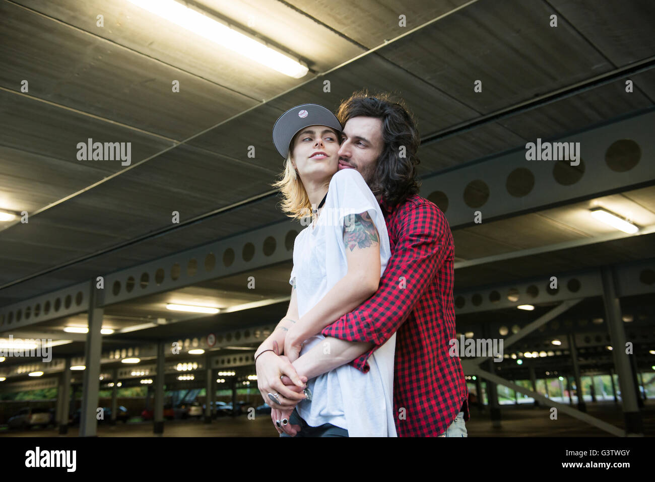 A cool young couple cuddling Stock Photo - Alamy