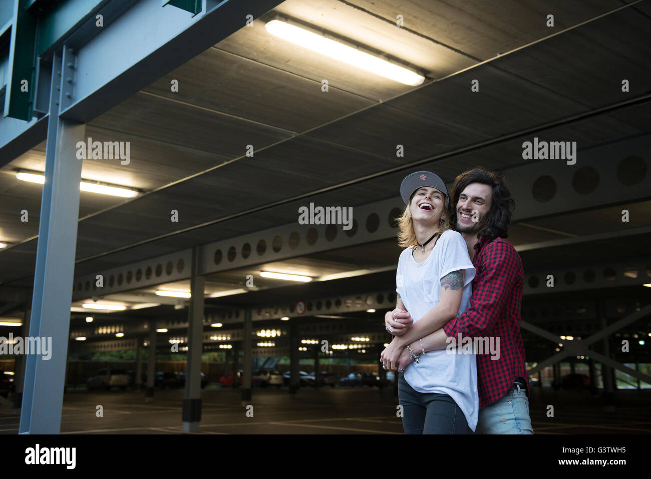 A cool young couple cuddling Stock Photo - Alamy