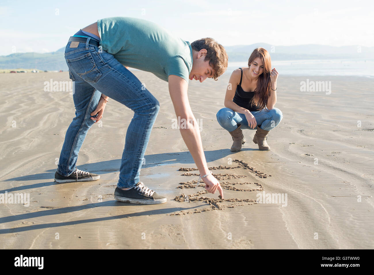 Couple writing sand hi-res stock photography and images - Alamy