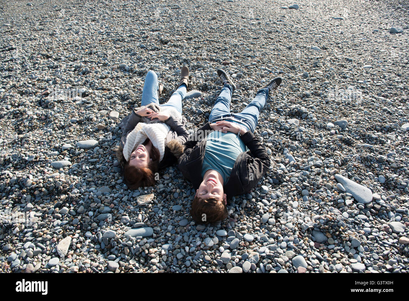 Beach couple laying down hi-res stock photography and images - Alamy