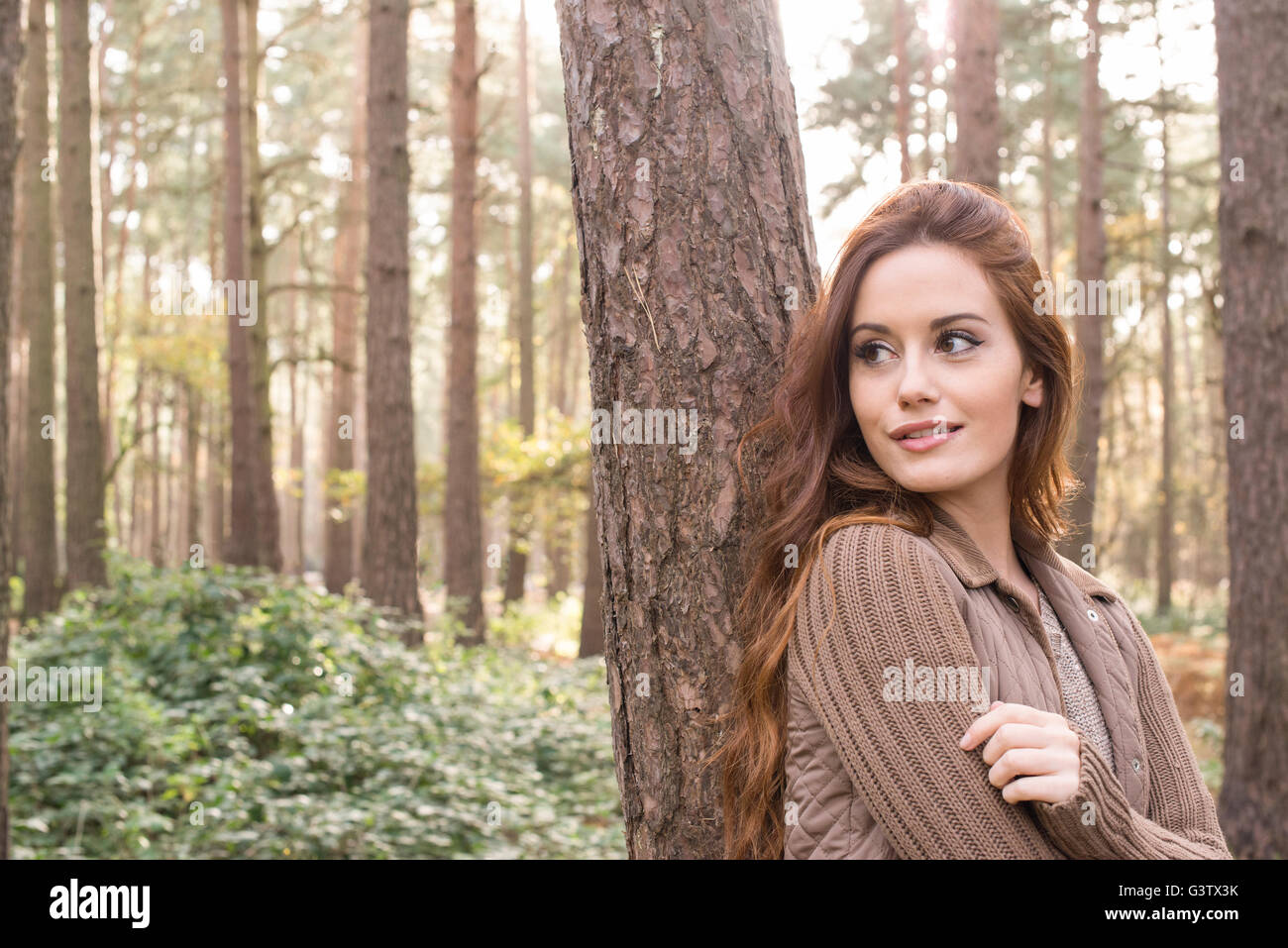 A young woman communing with nature in a forest in Autumn Stock Photo ...