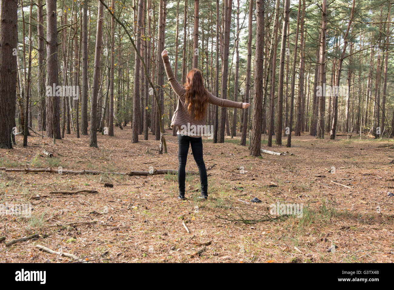 A young woman communing with nature in a forest in Autumn Stock Photo ...
