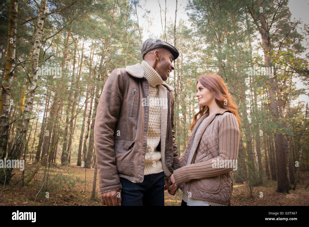 A young couple enjoying a forest walk in Autumn Stock Photo - Alamy