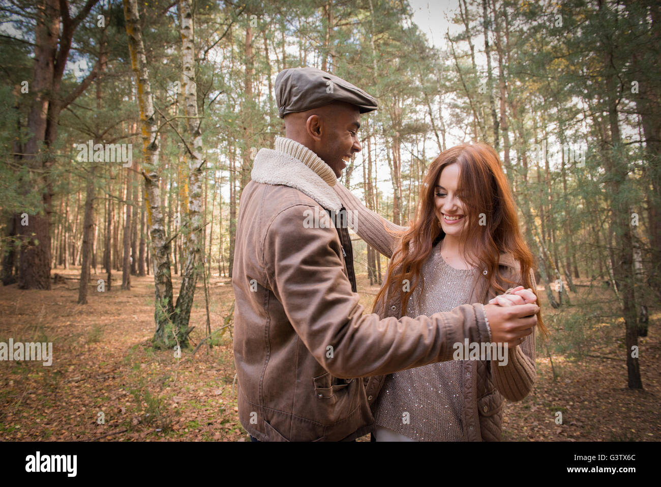 A young couple enjoying a forest walk in Autumn Stock Photo - Alamy