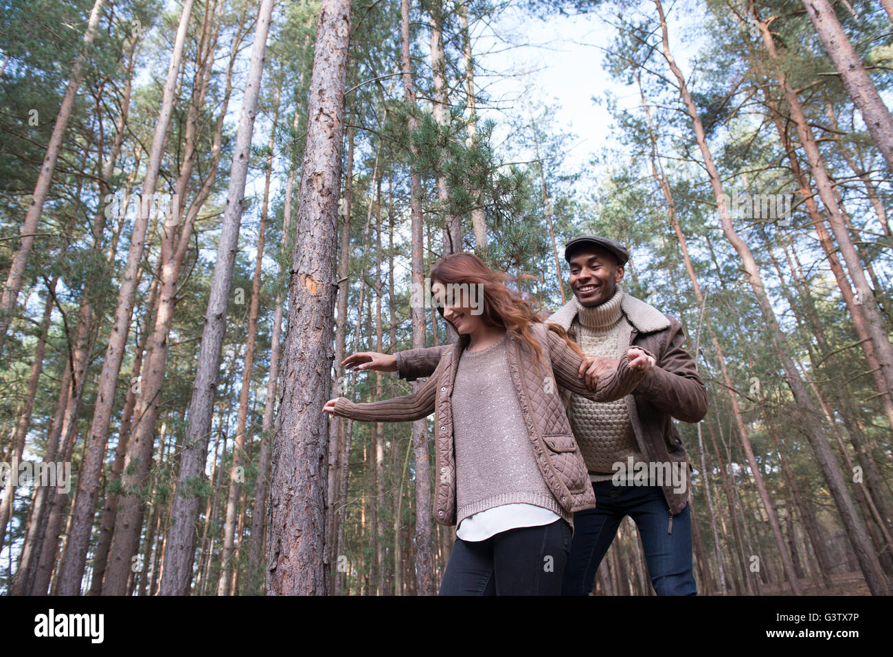 A young couple enjoying a forest walk in Autumn Stock Photo - Alamy