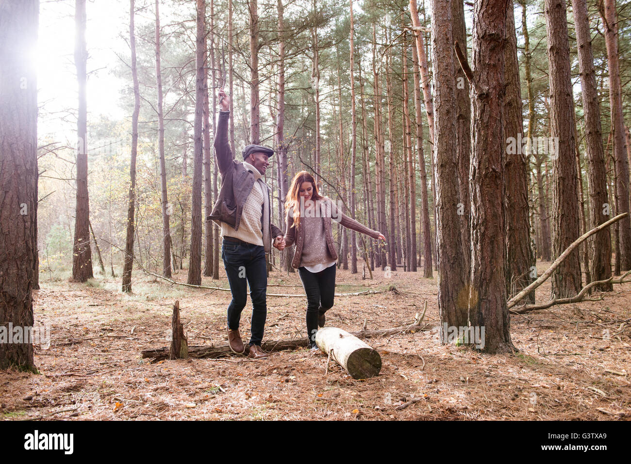 A young couple enjoying a forest walk in Autumn Stock Photo - Alamy