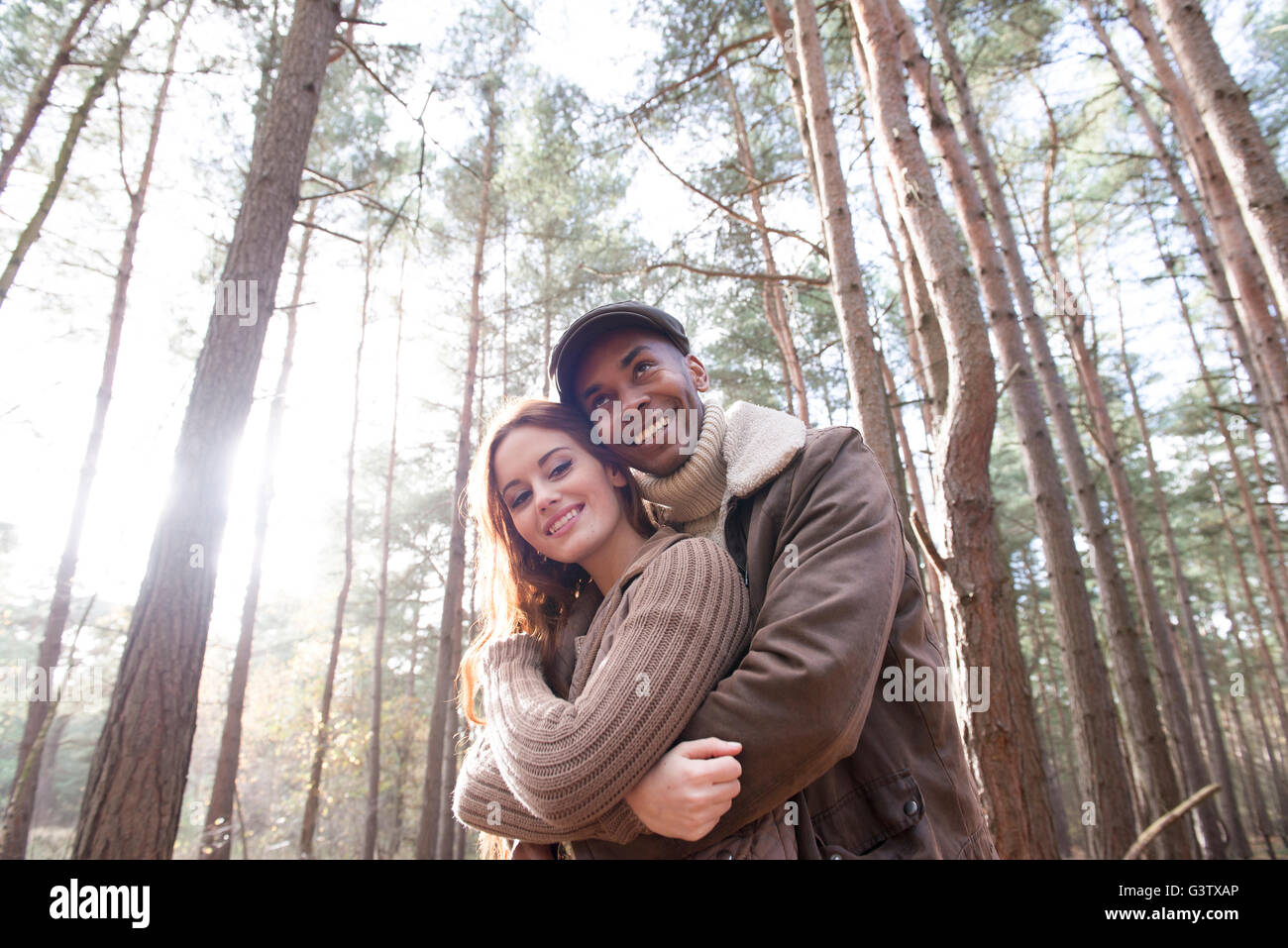 A young couple cuddling on a forest walk in Autumn Stock Photo - Alamy