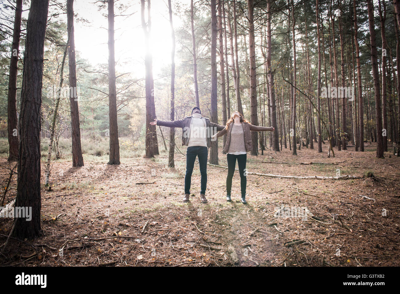 A young couple communing with nature on a forest walk in Autumn Stock ...