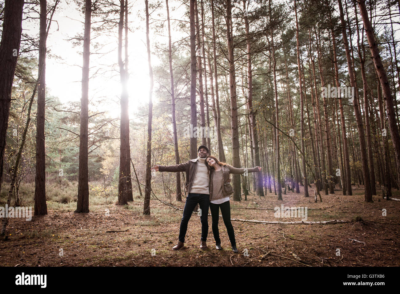 A young couple communing with nature on a forest walk in Autumn Stock ...