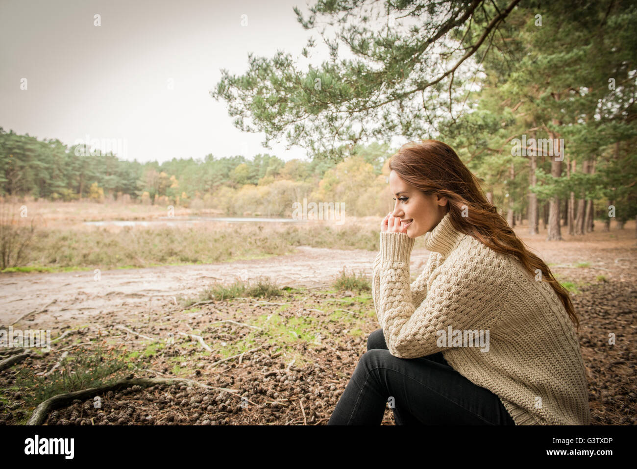 A young woman communing with nature on a forest walk in Autumn Stock ...