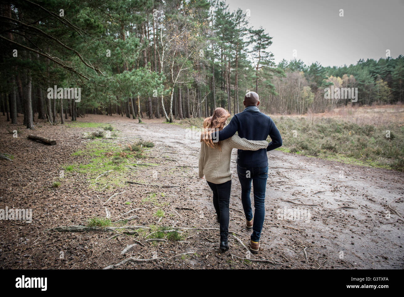 A young couple communing with nature on a forest walk in Autumn Stock ...