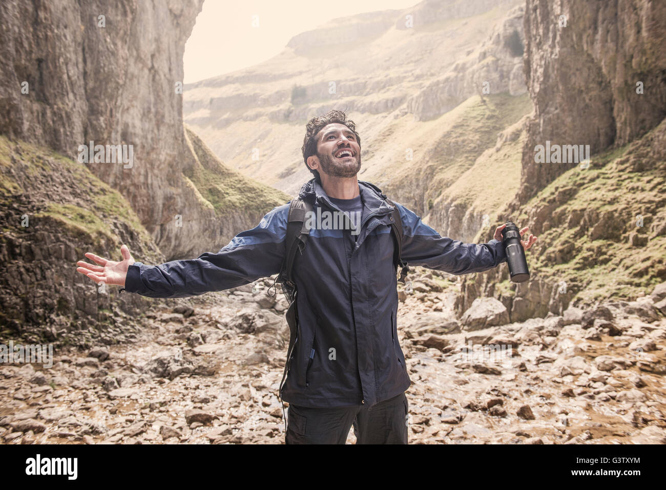 A mountaineer standing in rugged terrain Stock Photo - Alamy