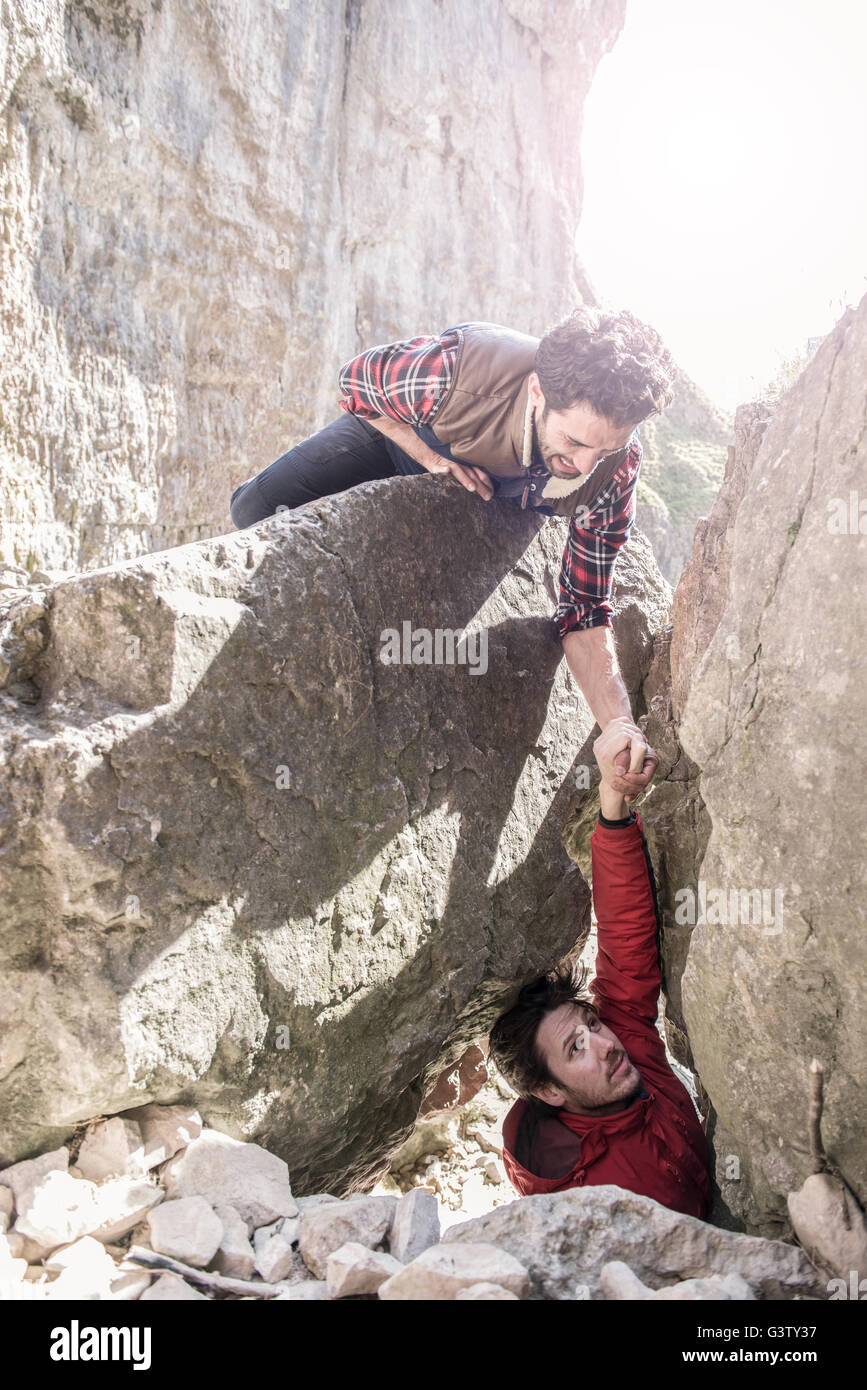 Adults helping each other climb hi-res stock photography and images - Alamy