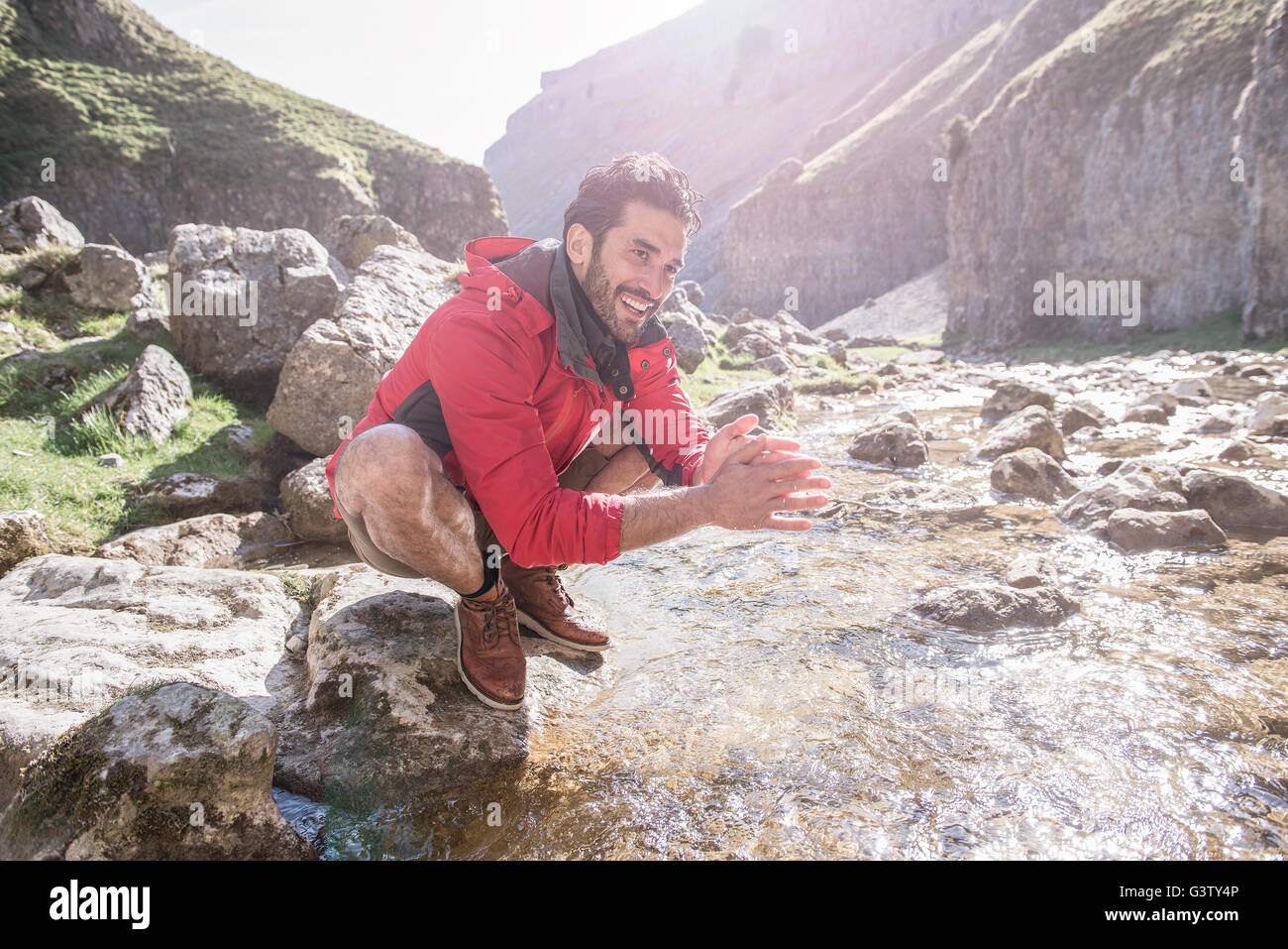 A mountaineer stopping to wash in a mountain stream Stock Photo - Alamy
