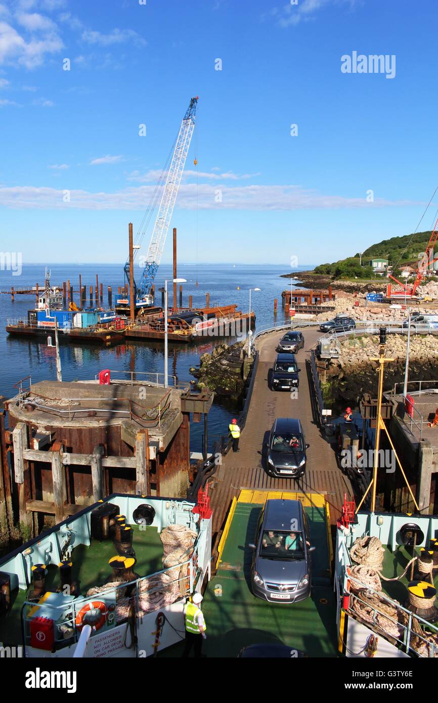 Cars loading onto a ferry at Brodick on the isle of Arran amidst ...