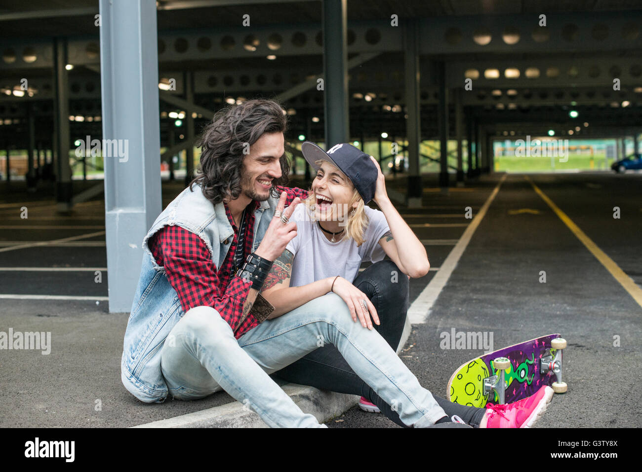 A cool young couple cuddling Stock Photo - Alamy