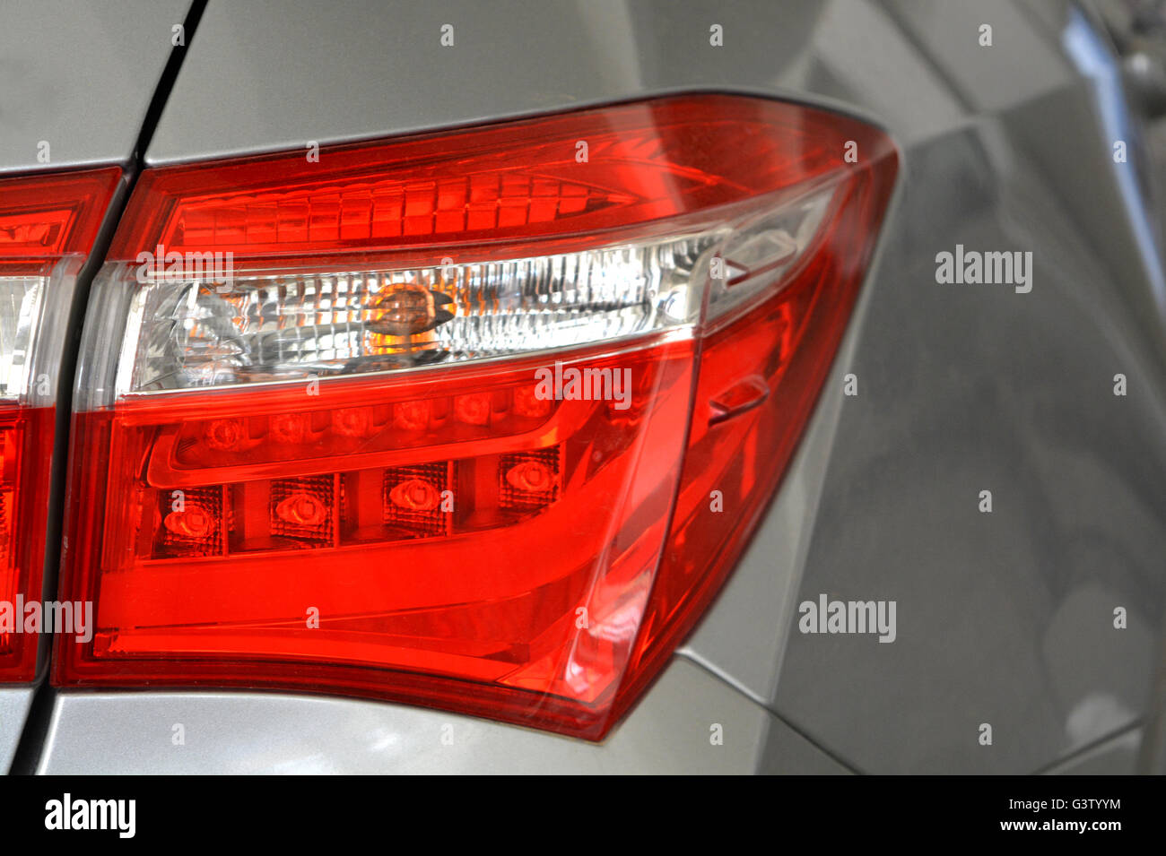 Detail of rear red lighthouse gray car with reflections Stock Photo - Alamy