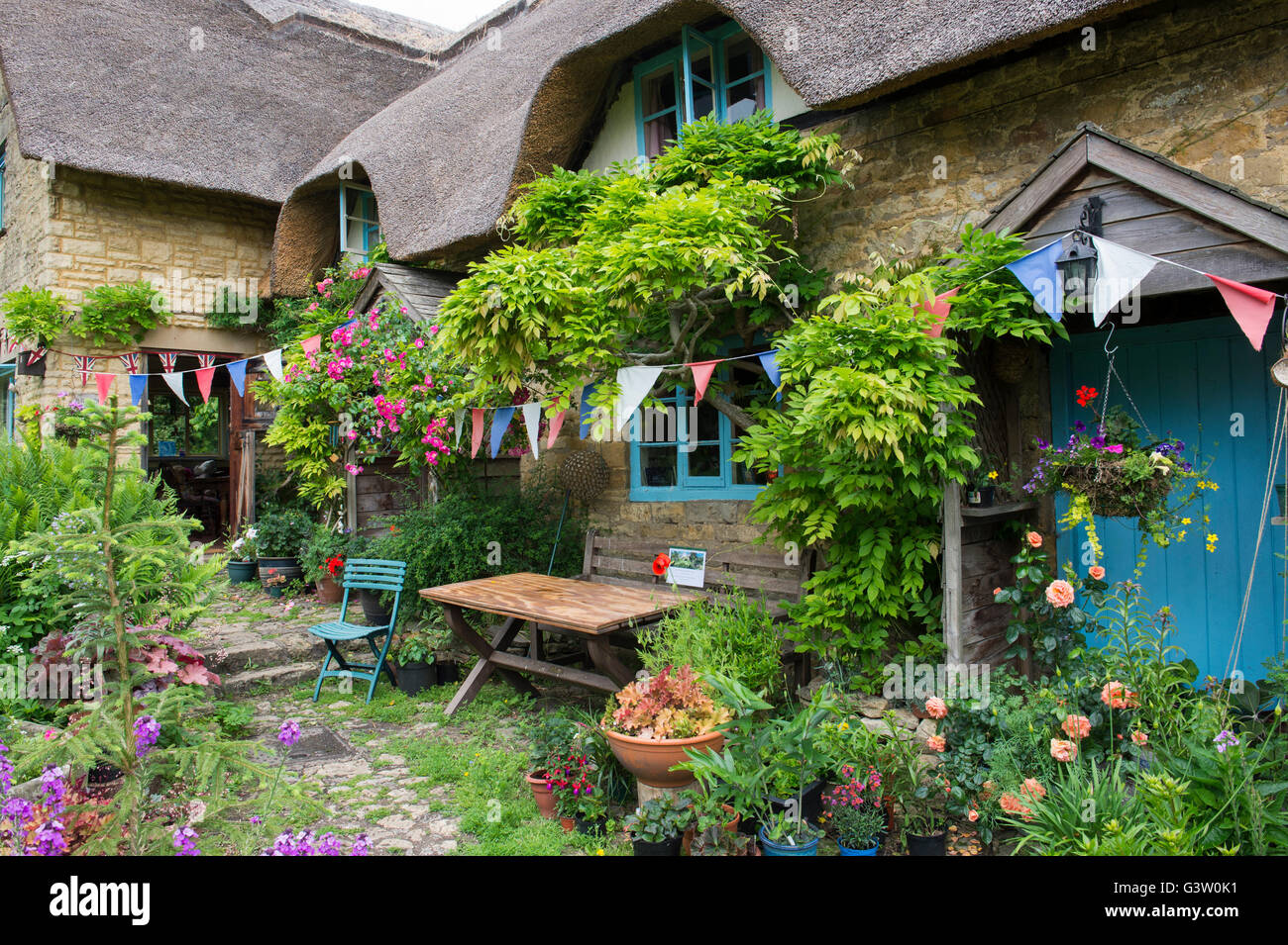 Thatched cottage and garden with bunting. Ashton Under Hill, Wychavon ...