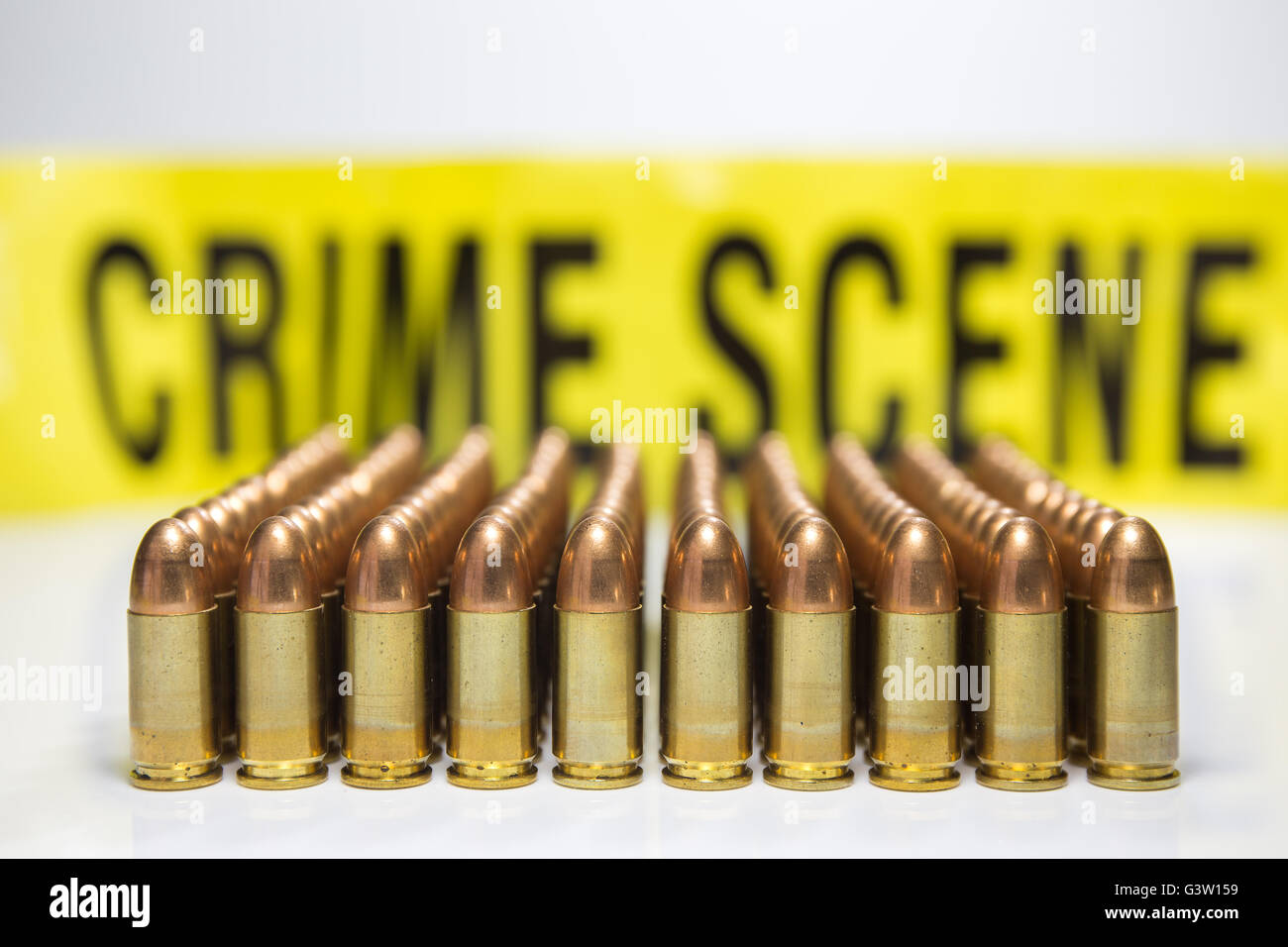 row of bullet with crime scene tape background Stock Photo - Alamy