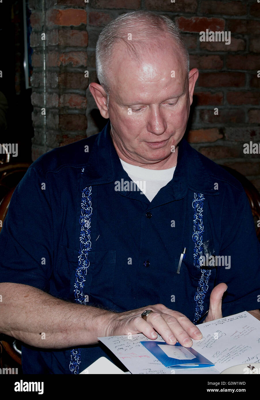 Older man reading a card he received at his retirement party Stock ...
