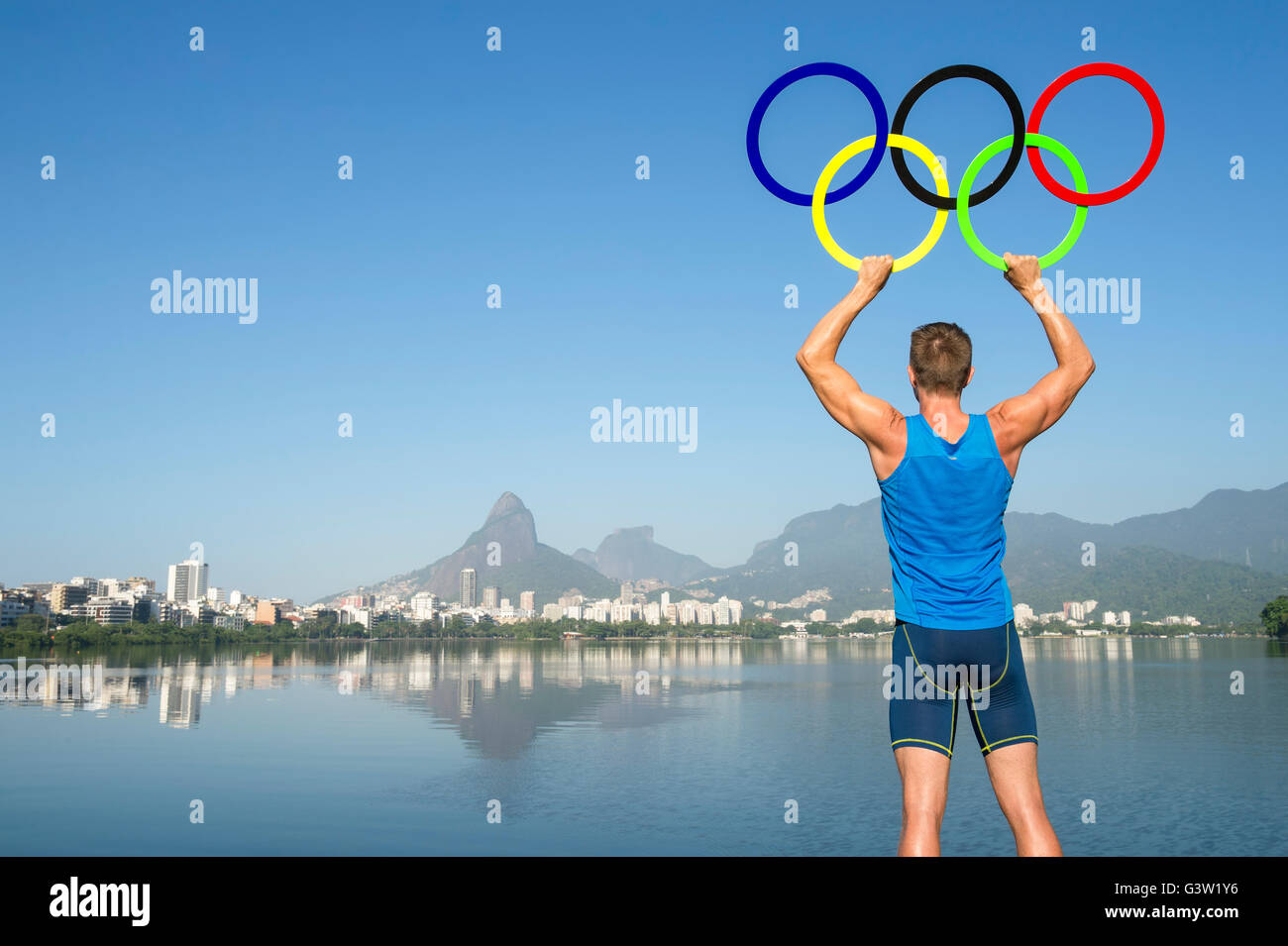 RIO DE JANEIRO - MARCH 27, 2016: Athlete holding Olympic rings stands ...