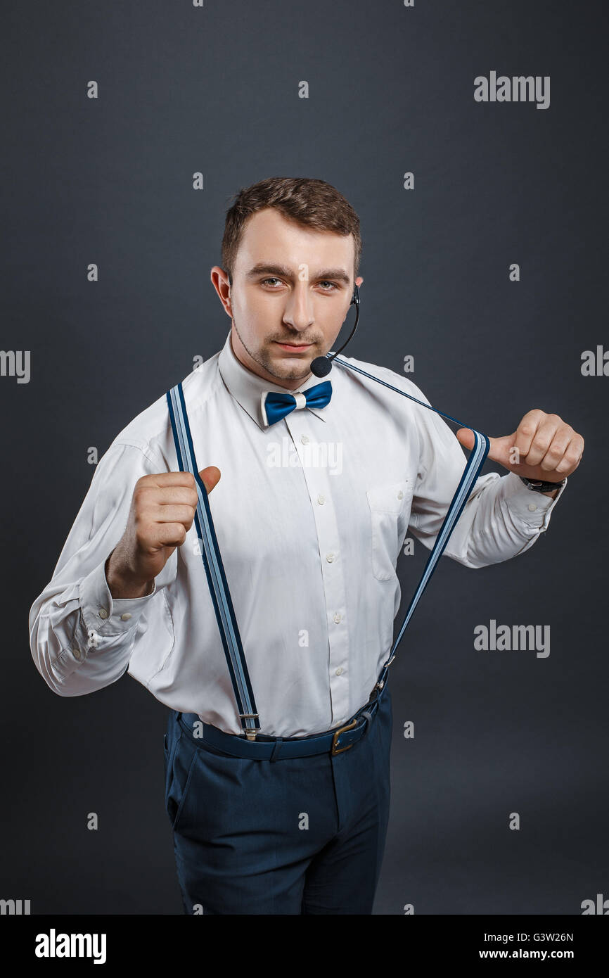 Portrait of stylish man in suspenders and bow-tie Stock Photo - Alamy