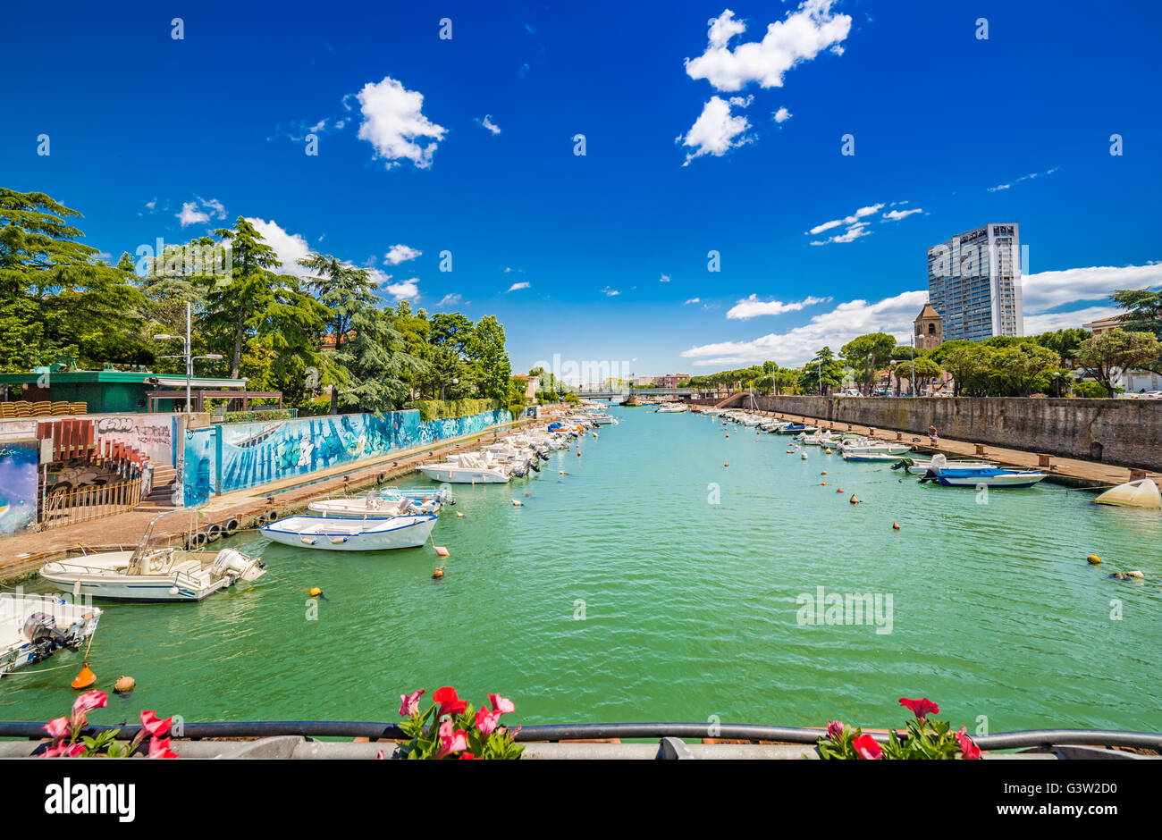 Scenic spring view of pier with ancient and modern buildings, ships ...
