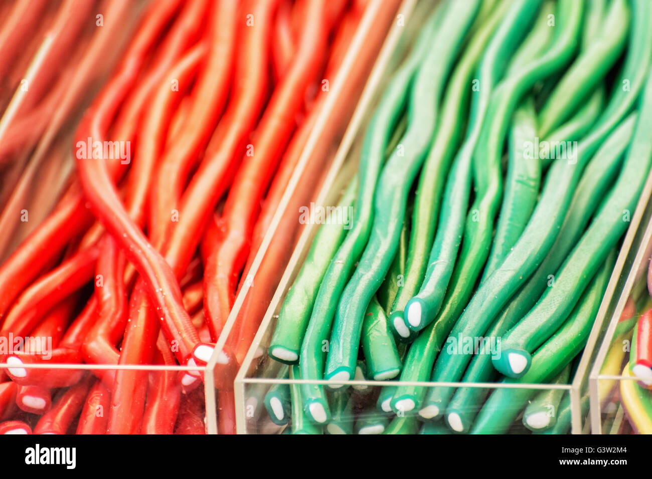 Colorful tasty licorice candies in plastic containers. Sweet delight ...