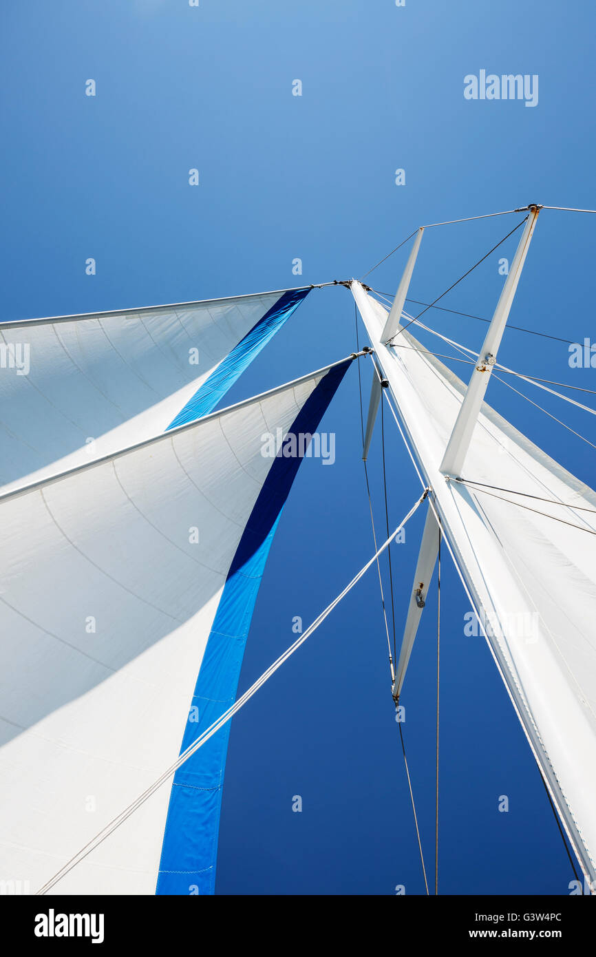 Sailing with open sails on a sailboat mast on a blue sky Stock Photo ...