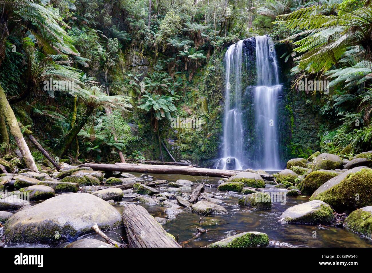 Enjoying the peace from the sound of the waterfall Stock Photo - Alamy