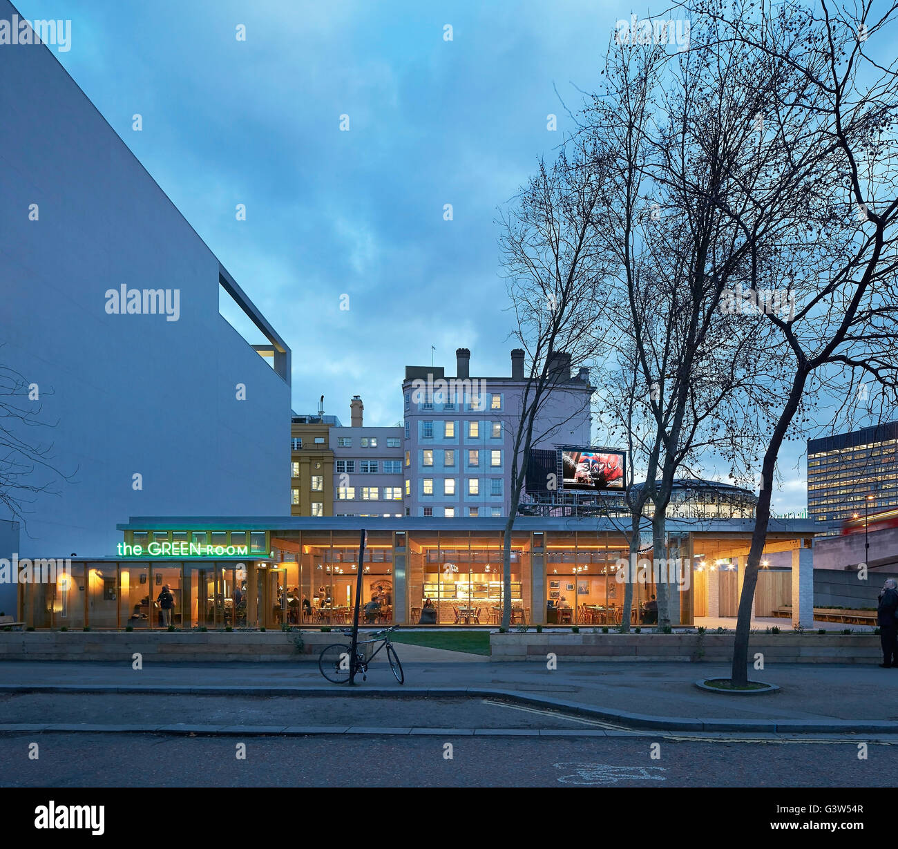 Contextual dusk elevation with illuminated restaurant interior. The ...