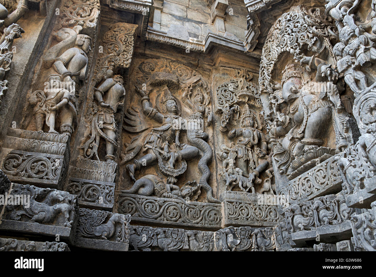 Wall panel relief. Hindu deities, Garuda fighting with the snakes in ...