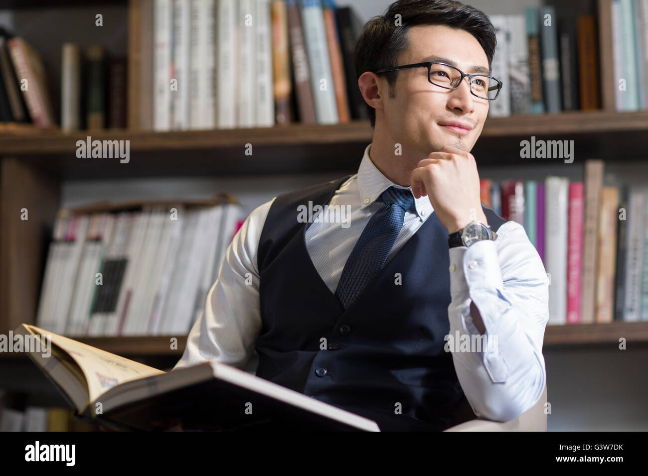 Young businessman thinking in his study Stock Photo - Alamy