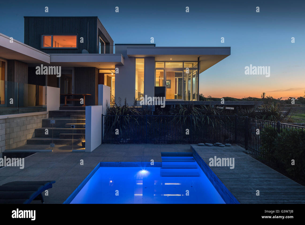 Side of house with pool lit at night. Waikanae House, Peka Peka ...