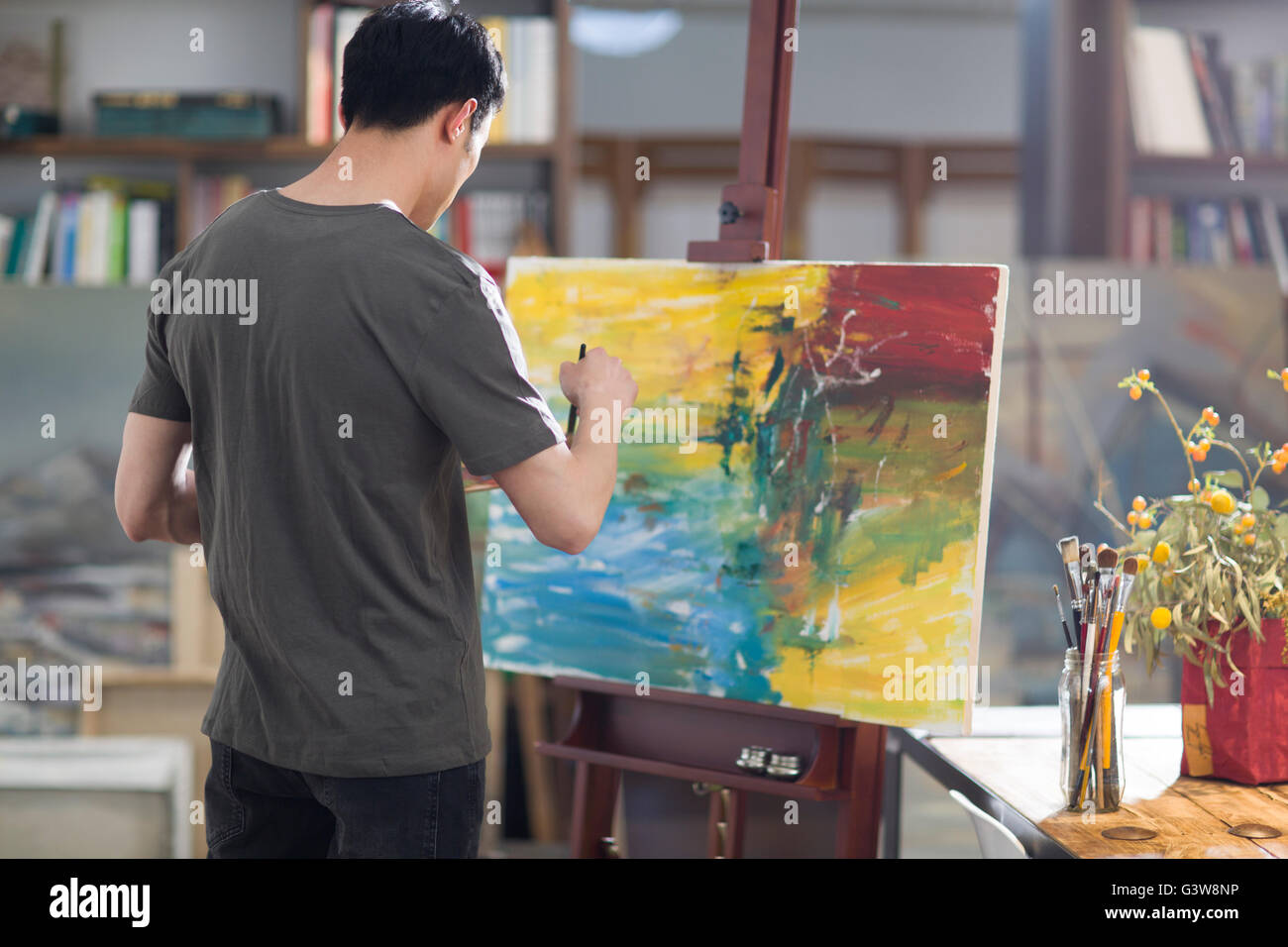 Artist painting in his studio Stock Photo - Alamy