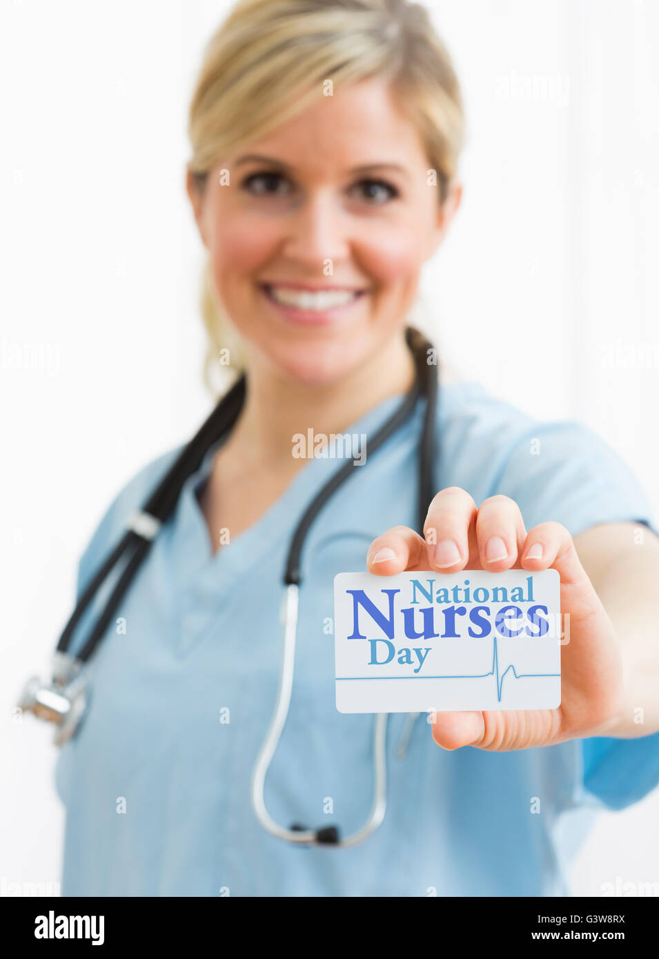 Blonde nurse smiling holding stethoscope hi-res stock photography and images - Alamy