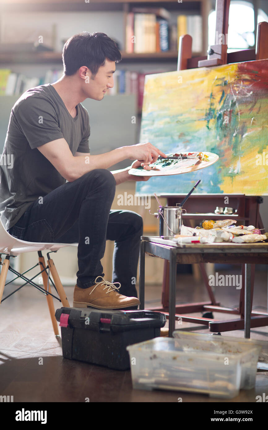 Artist painting in his studio Stock Photo - Alamy
