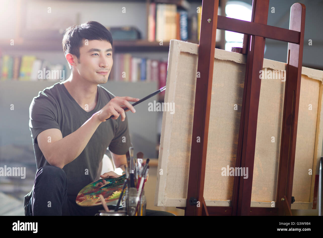 Artist painting in his studio Stock Photo - Alamy