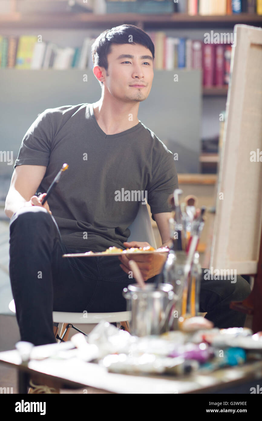 Artist painting in his studio Stock Photo - Alamy