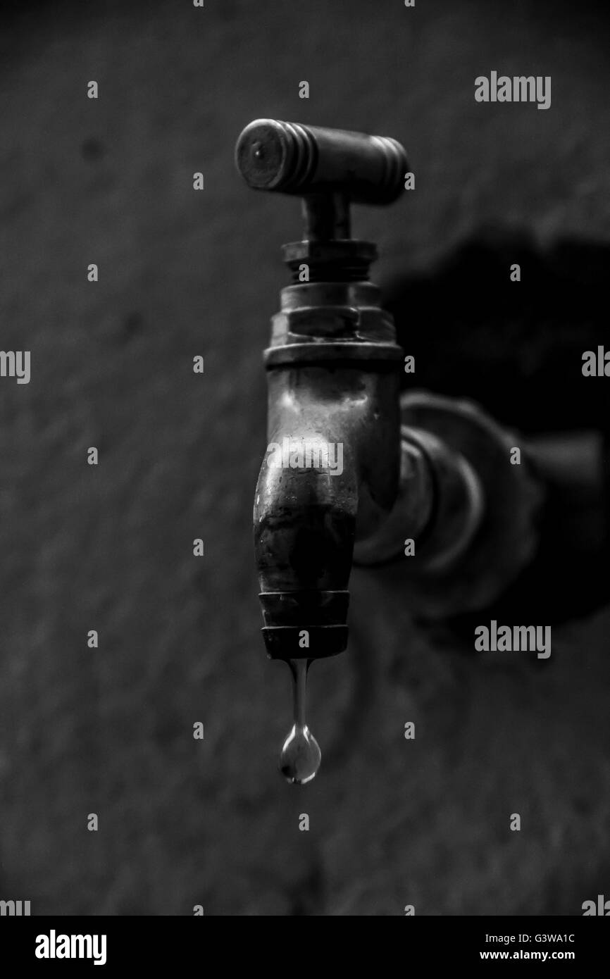 water droplet captured as it drops from the tap Stock Photo - Alamy
