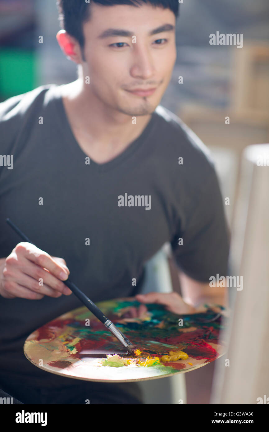 Artist painting in his studio Stock Photo - Alamy