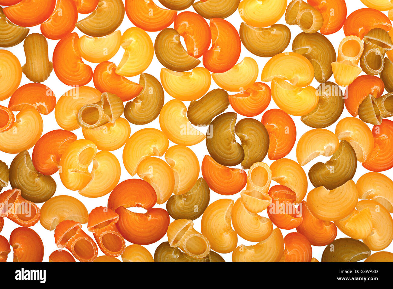 Multicolor dry swirl pasta closeup background Stock Photo - Alamy