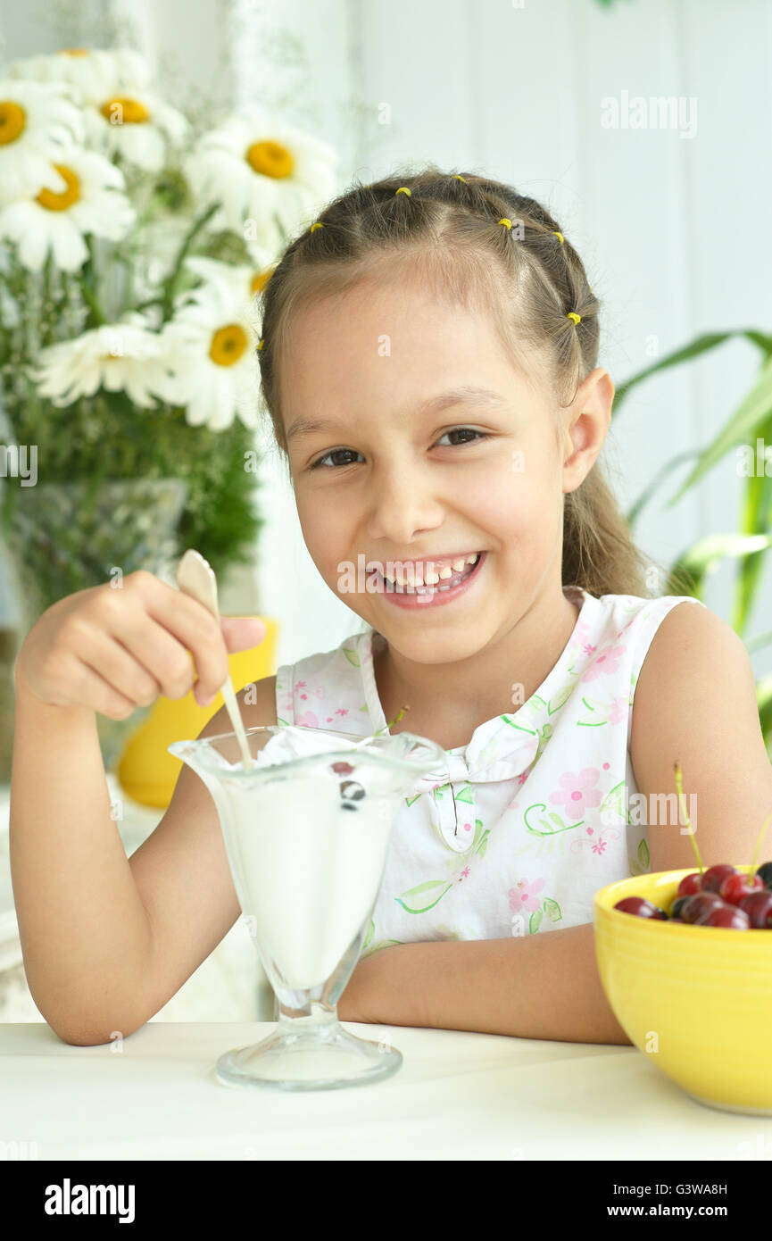 Girl eating sweet dessert with berries Stock Photo - Alamy