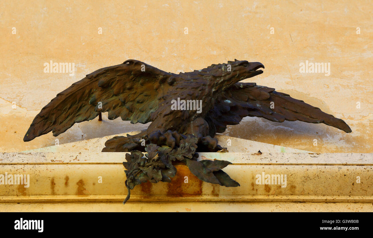 Old Eagle of metal attached to a wall in a country of Lazio in Italy ...