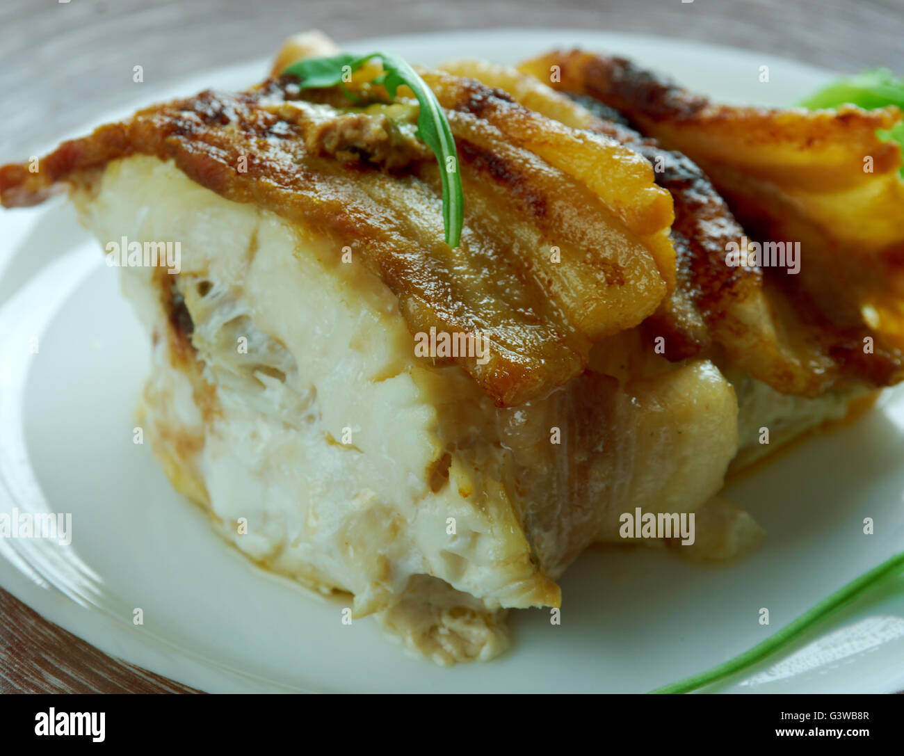 Baked cod wrapped in bacon Stock Photo - Alamy